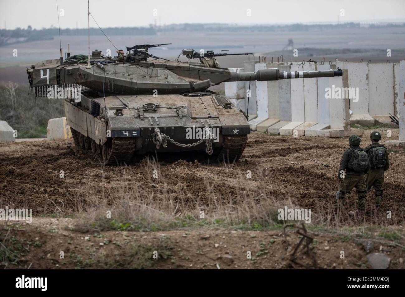 An Israeli tank and soldiers take positions on the Israel Gaza border ...