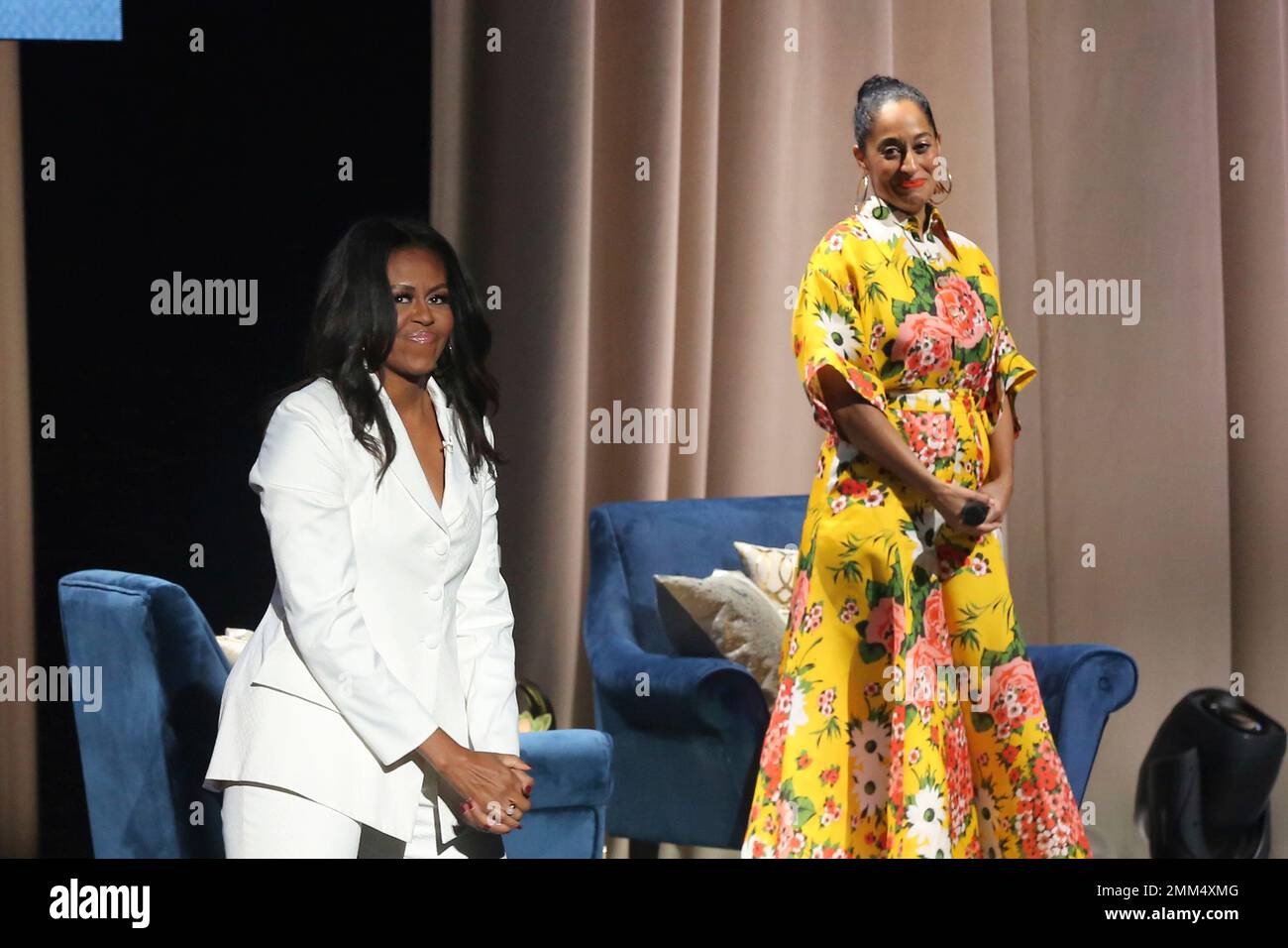 Former first lady Michelle Obama, left, enters the stage after being ...