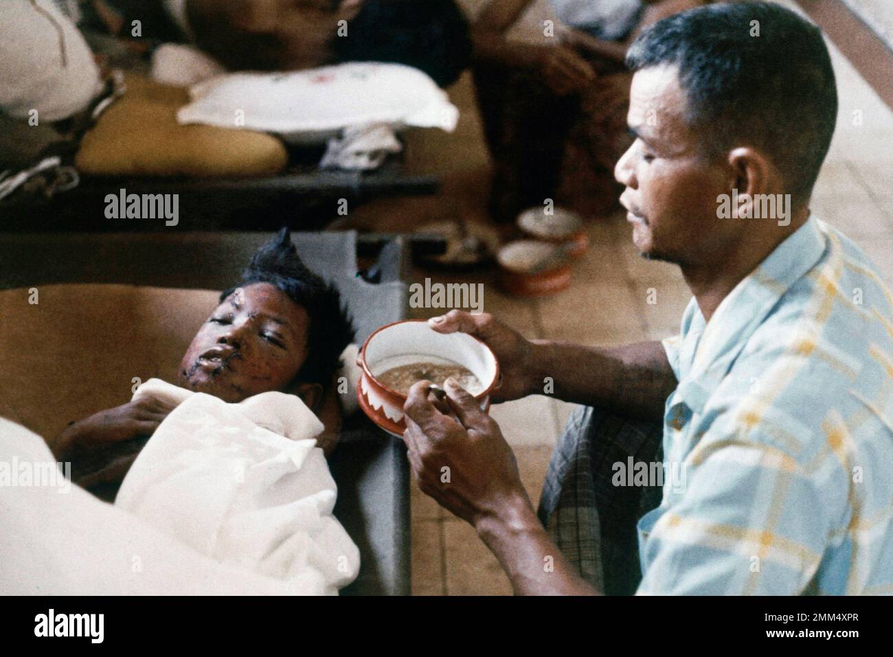 FILE - In this in February 1974, file photo, a Cambodian father kneels ...