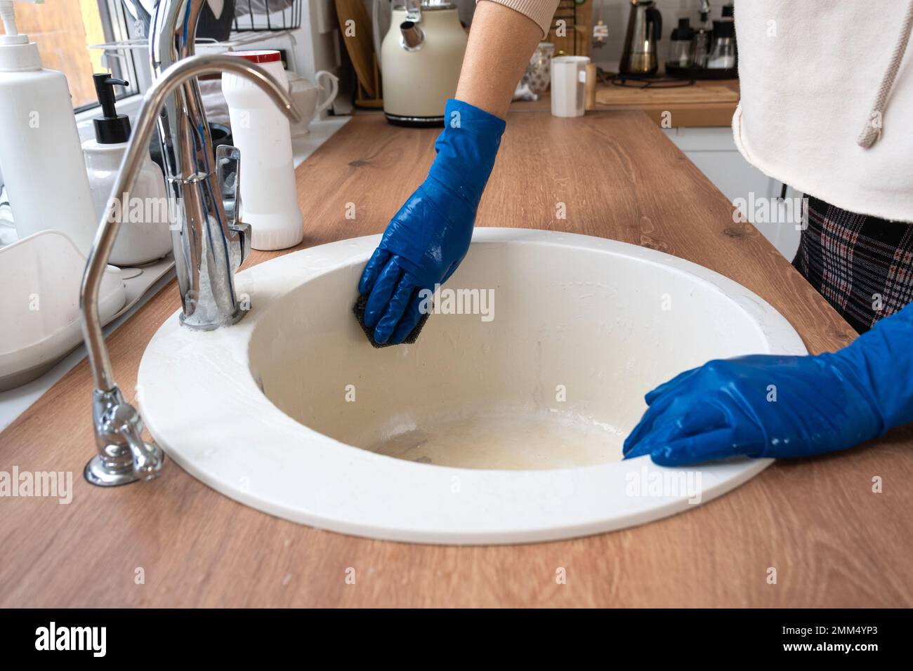 Cleaning sink in kitchen, Hand in gloves and sponge, detergent, dry ...