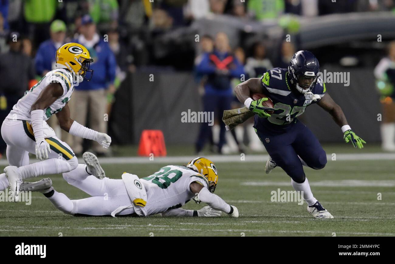 Seattle Seahawks running back Mike Davis , right, rushes against the ...