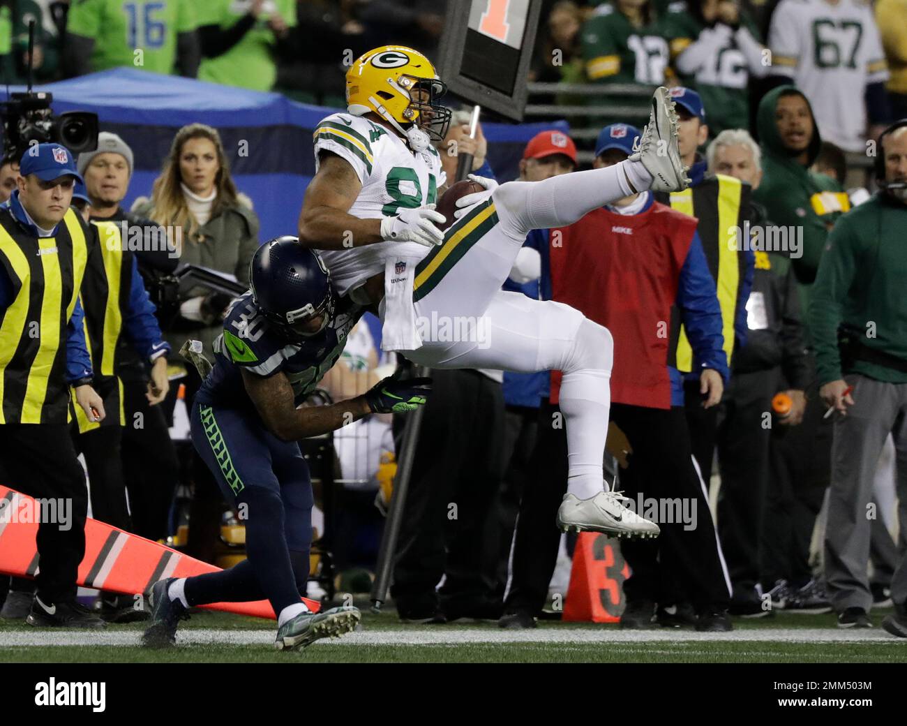 Green Bay Packers tight end Lance Kendricks, right, pulls down a catch ...
