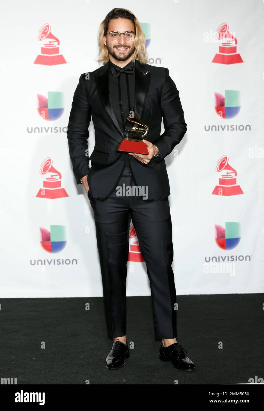 Maluma poses in the press room with the award for best contemporary pop ...