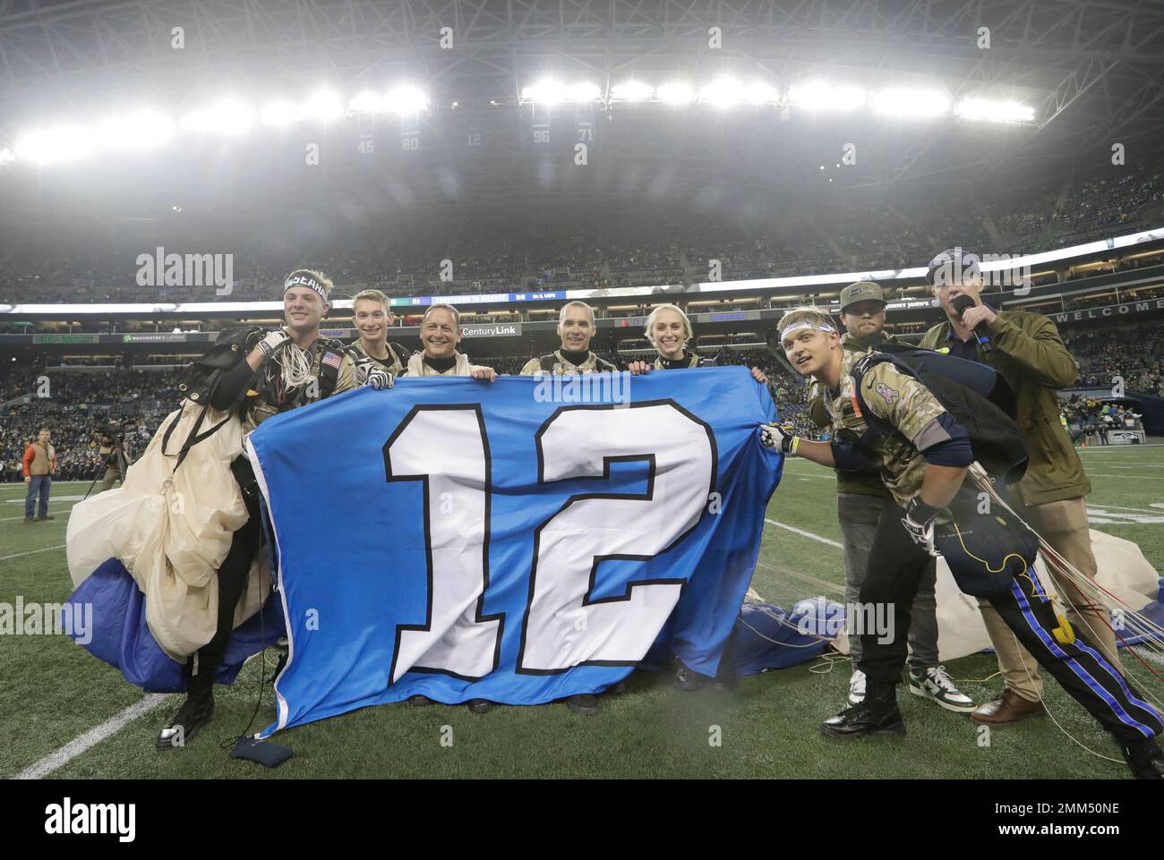 Military parachutists pose for a photo after they landed at CenturyLink ...