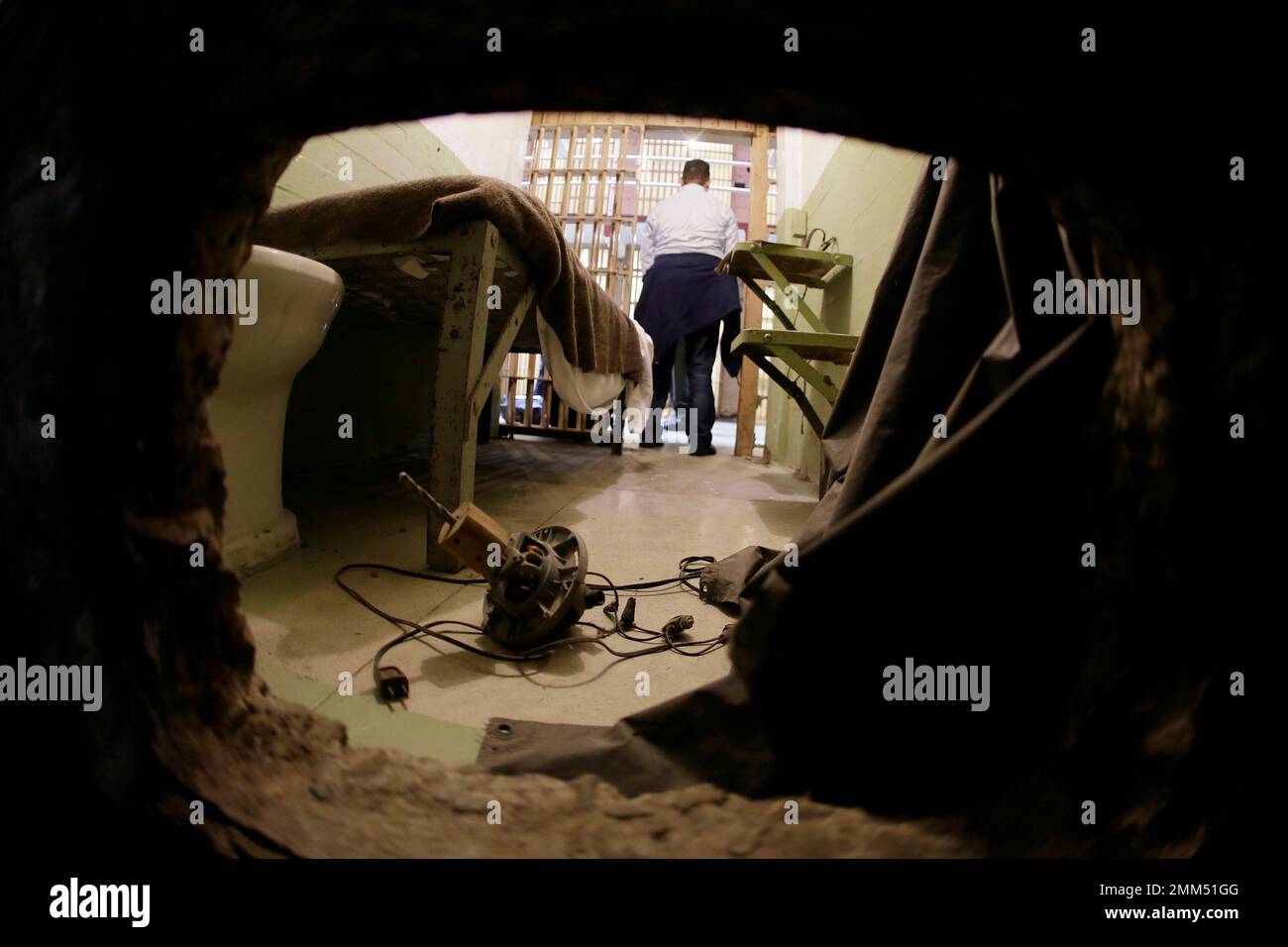 Through this hole cut into the back of a prison cell is the way one of ...