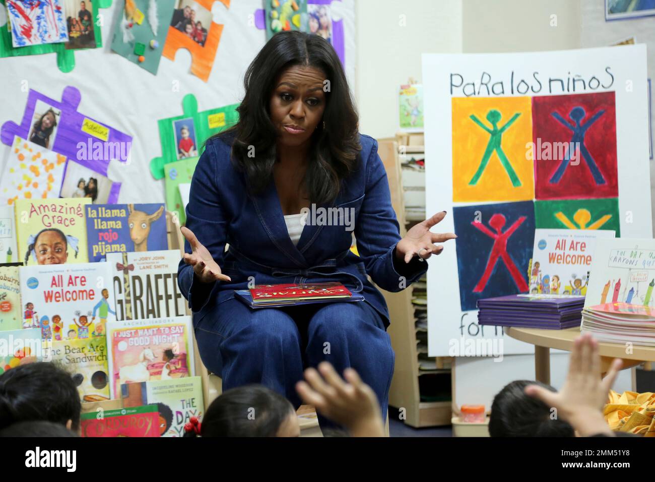 Former first lady Michelle Obama reads a book to some school kids during a surprise appearance ...