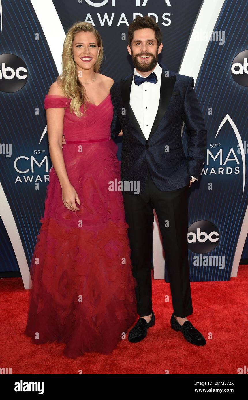 Lauren Akins, left, and Thomas Rhett arrive at the 52nd annual CMA ...