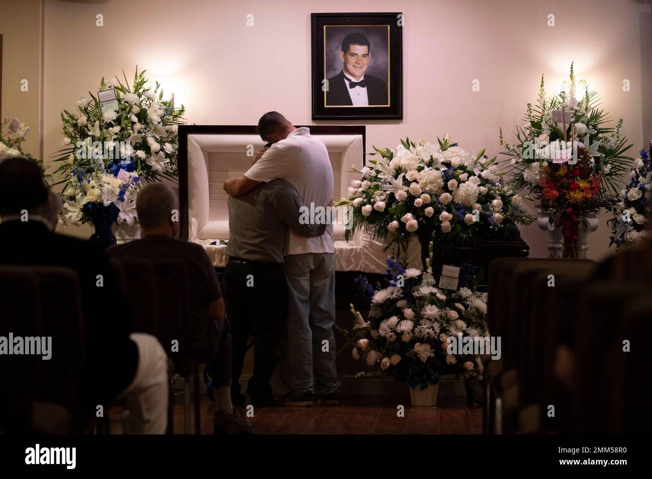 Jason Coffman, center right, father of Cody Coffman, is comforted by ...