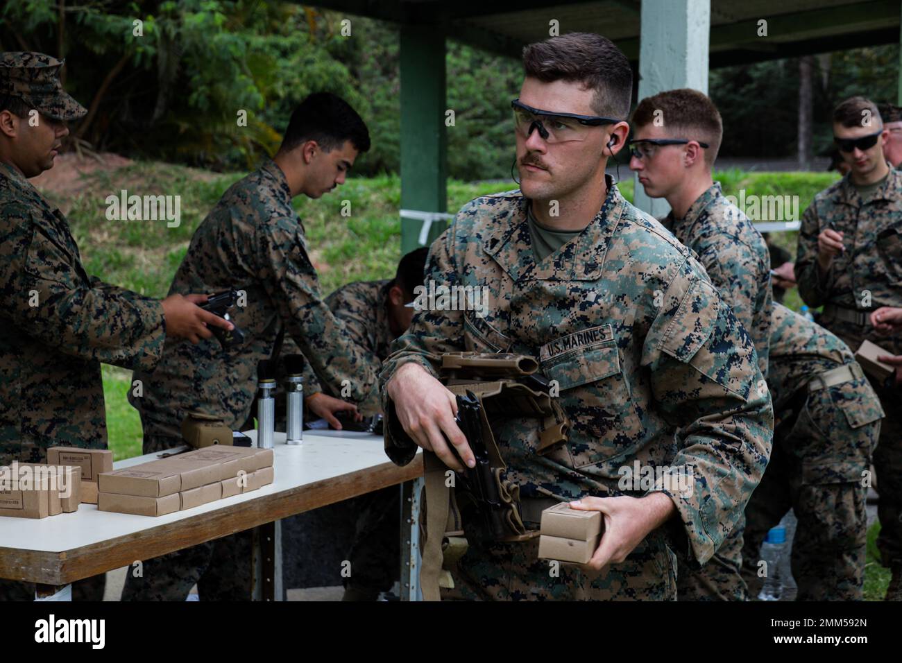 U.S. Marines get issued an M9 pistol during a pistol qualification ...