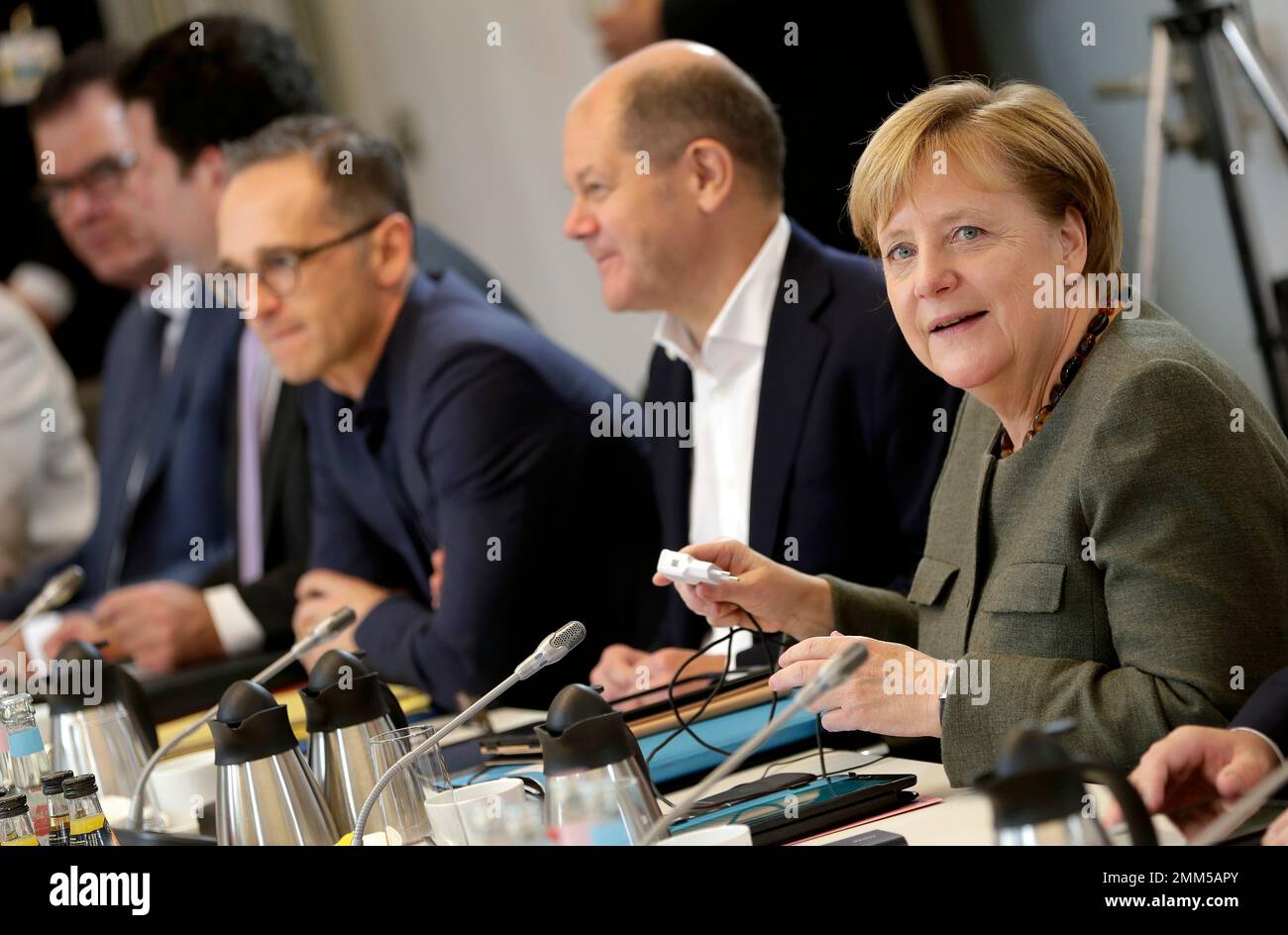 German Chancellor Angela Merkel, right, attends a cabinet meeting as ...