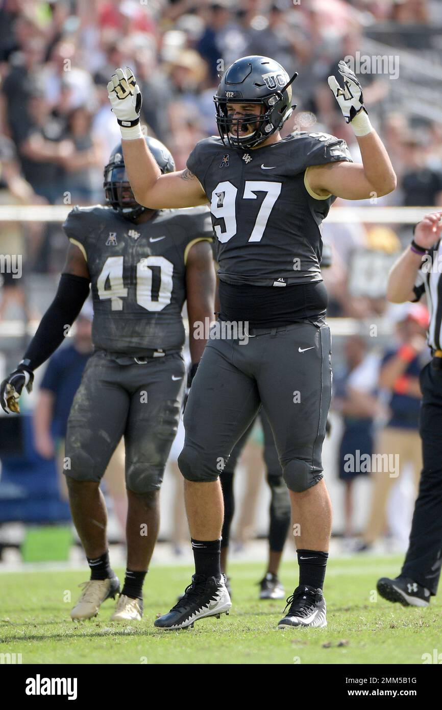 Central Florida defensive lineman Mason Cholewa (97) encourages the ...