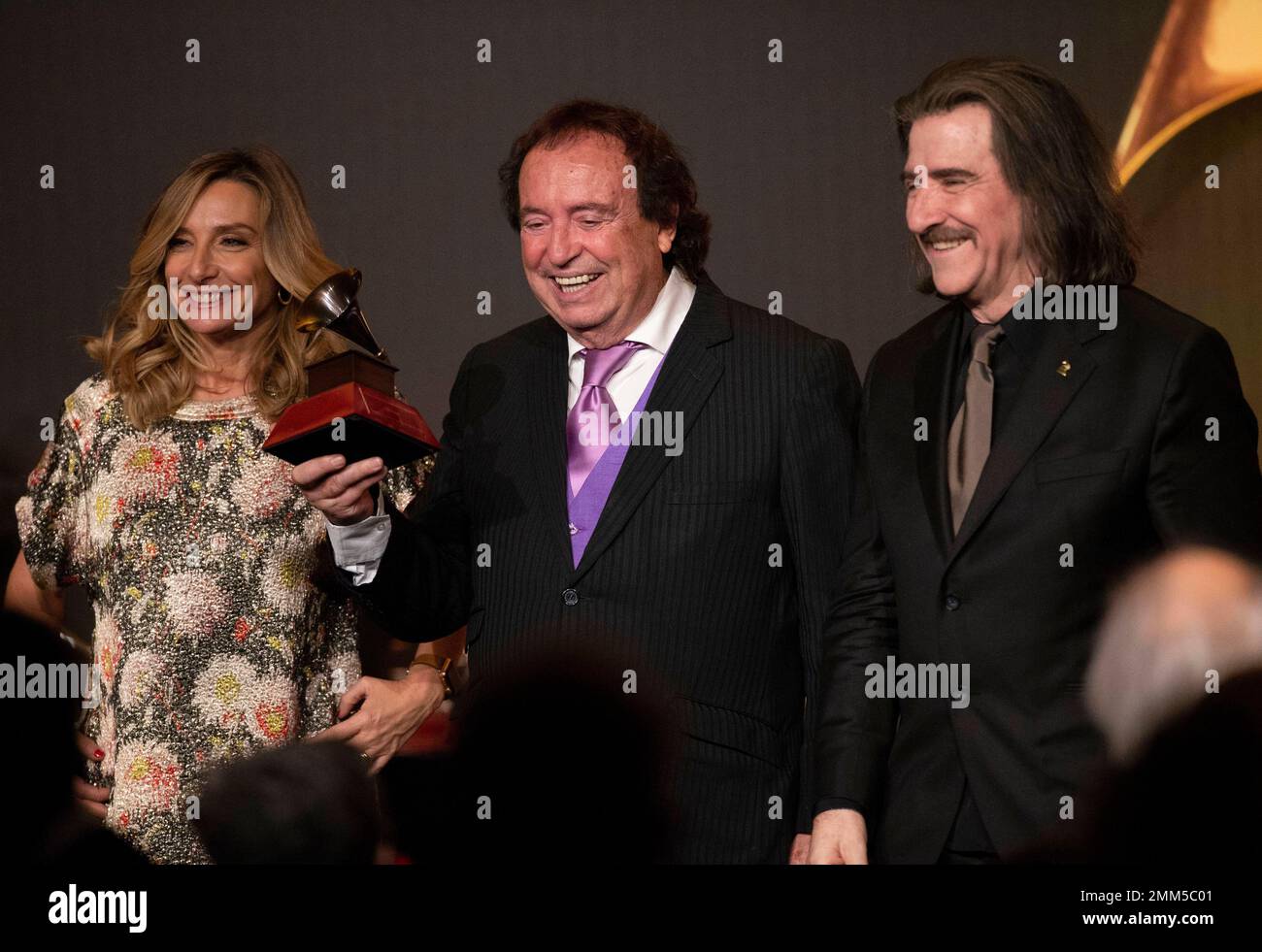 Dyango, center, receives the Lifetime Achievement award from Eva ...