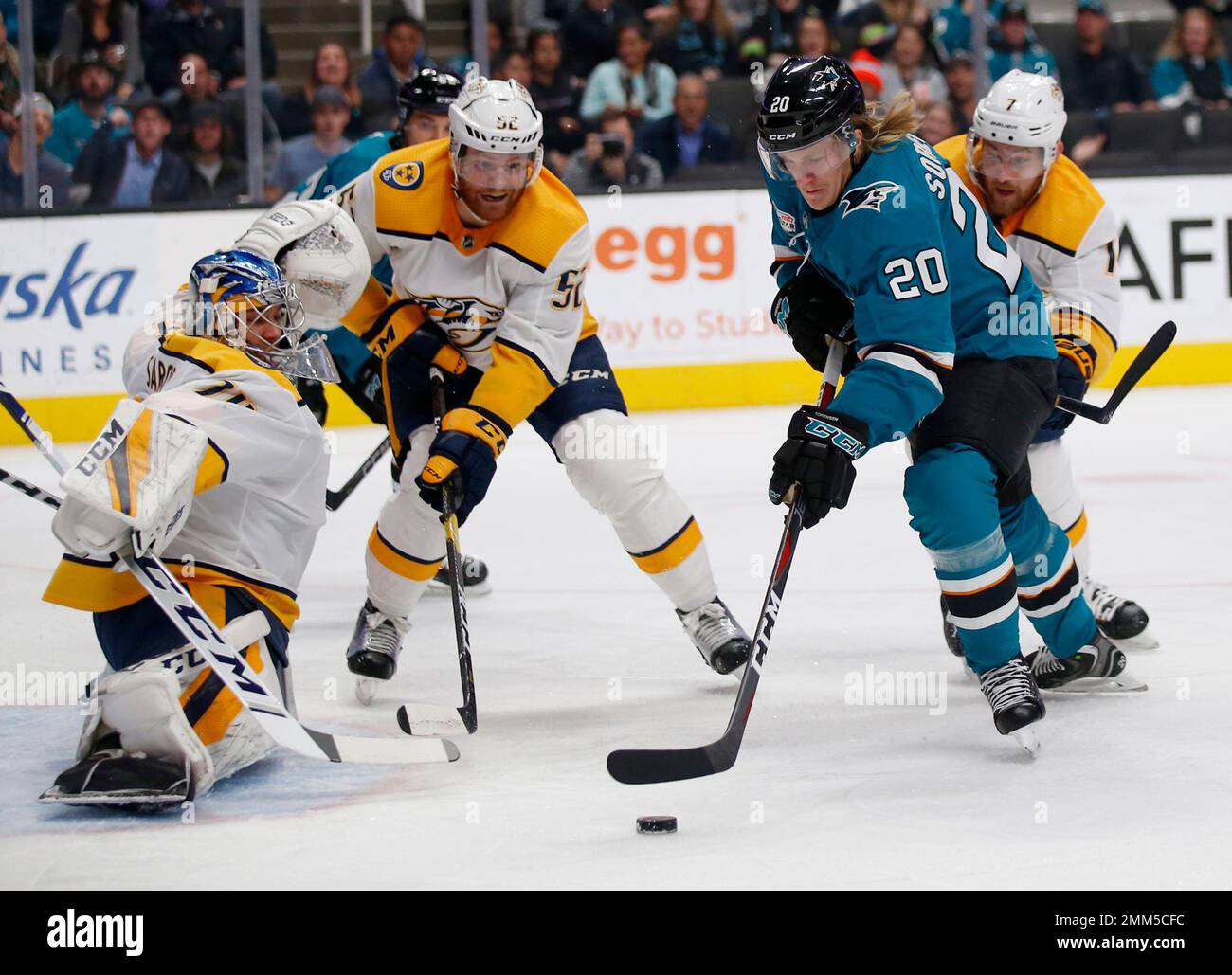 Nashville Predators goaltender Juuse Saros (74), Nashville Predators' Matt Irwin (52) battle for ...