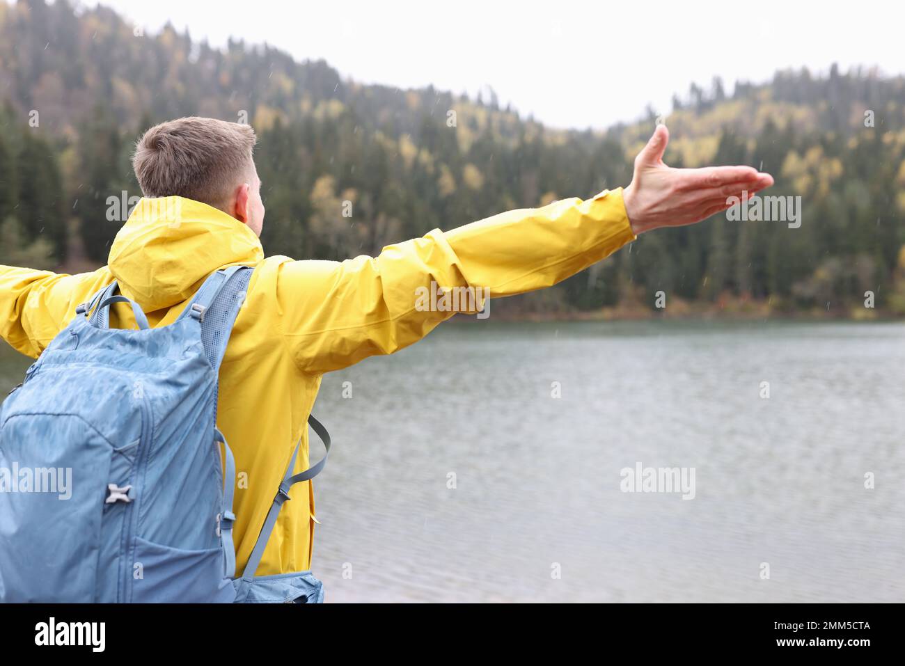 Male traveler with backpack is happy to see his travel destination ...