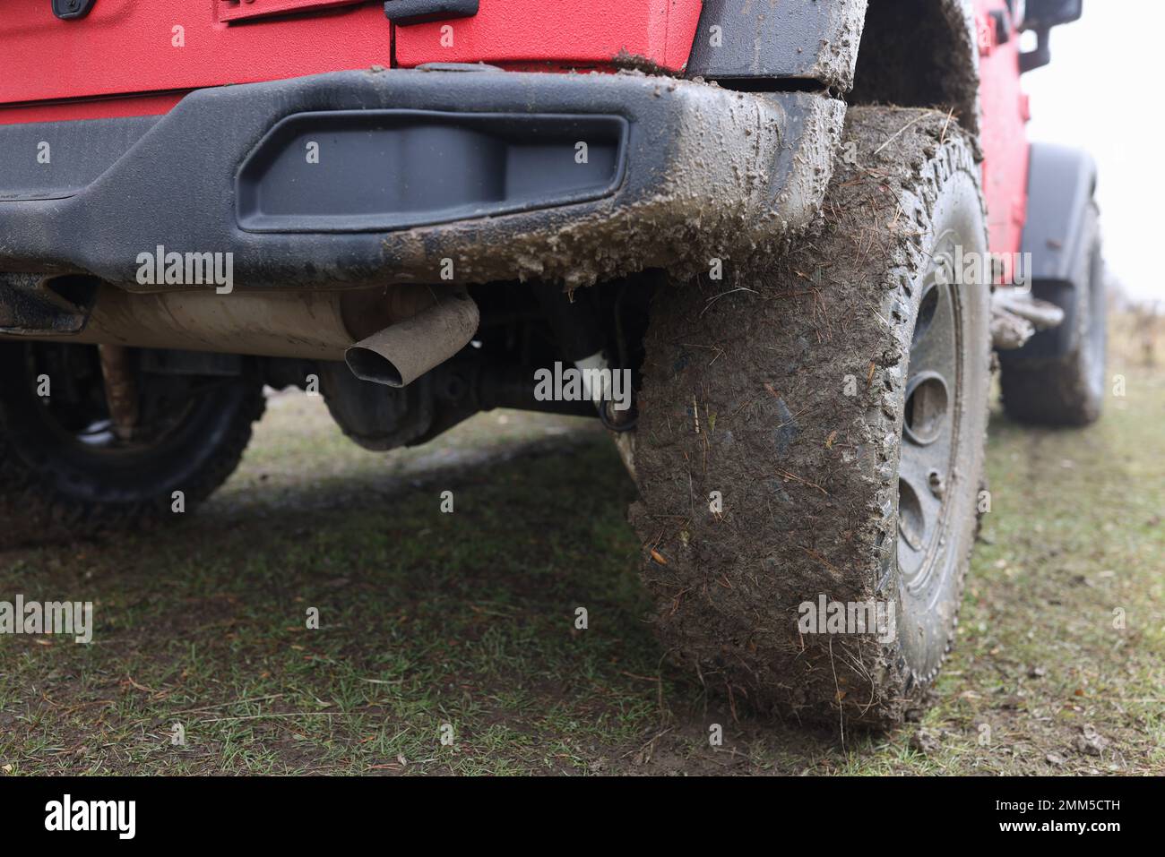 Dirty wheels of red offroad car close-up Stock Photo - Alamy