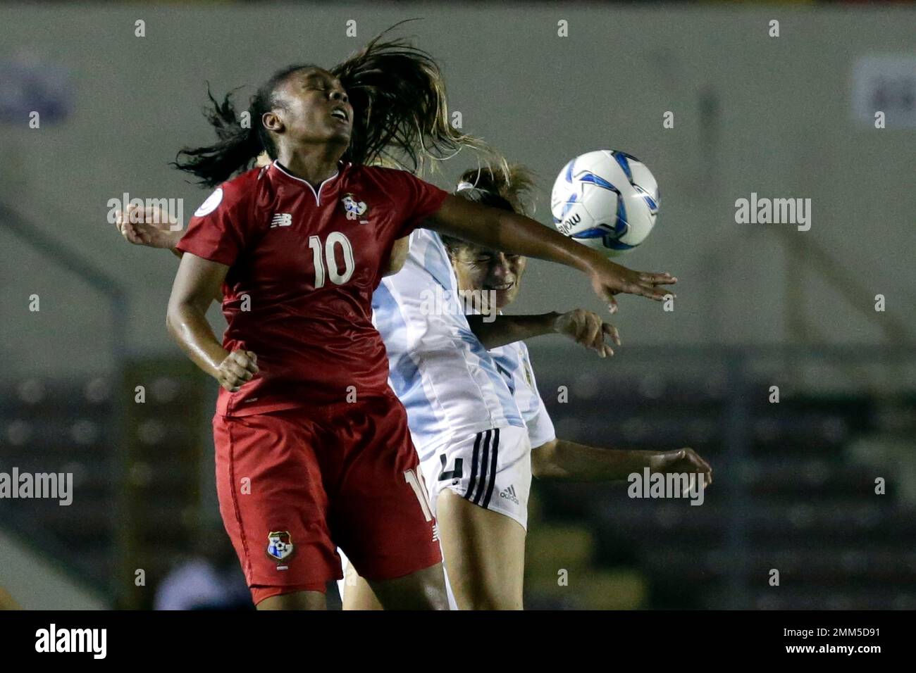Panama's Marta Cox, 10, and Argentina's Adriana Sachs jump for the ball ...