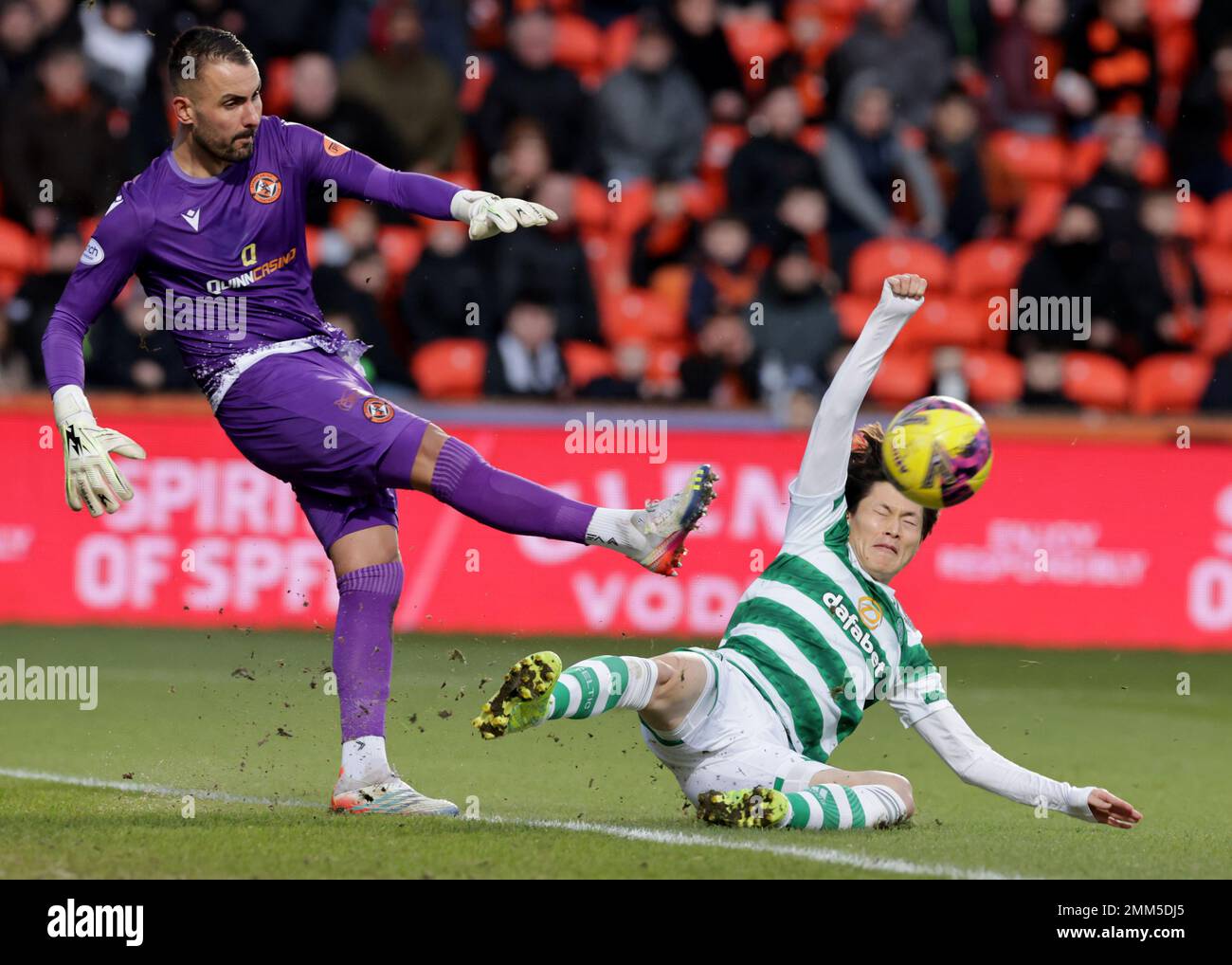 Dundee United goalkeeper Mark Birighitti clears the ball whilst Celtic ...