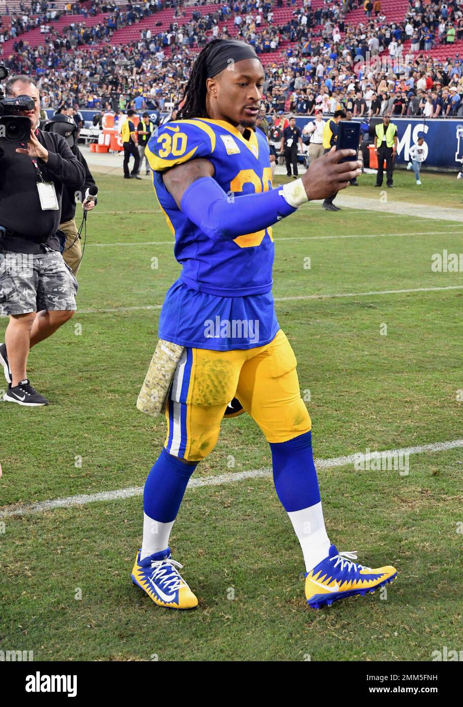Los Angeles Rams running back Todd Gurley II (30), holding a phone ...