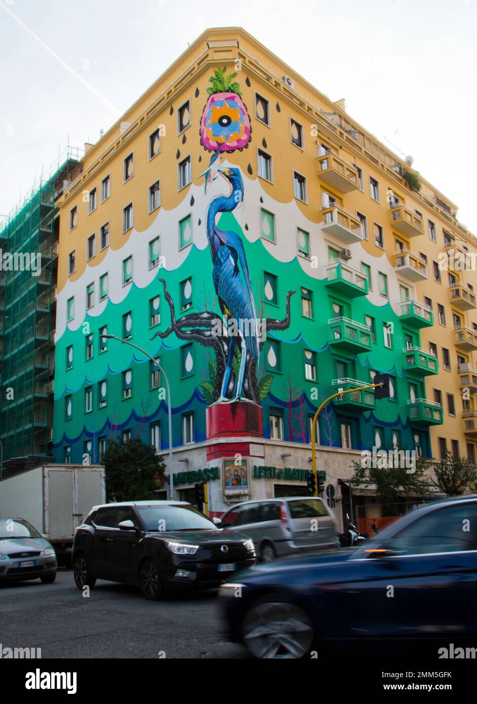 Car pass by a building decorated by a murals by Italian street artist ...