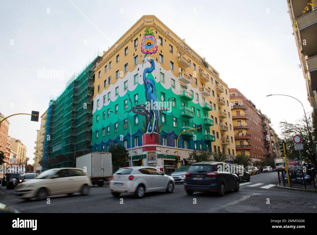 Car pass by a building decorated by a murals by Italian street artist ...