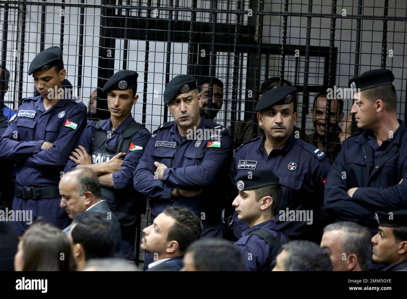 Guards surround the defendants' cage in Jordan's state security court ...