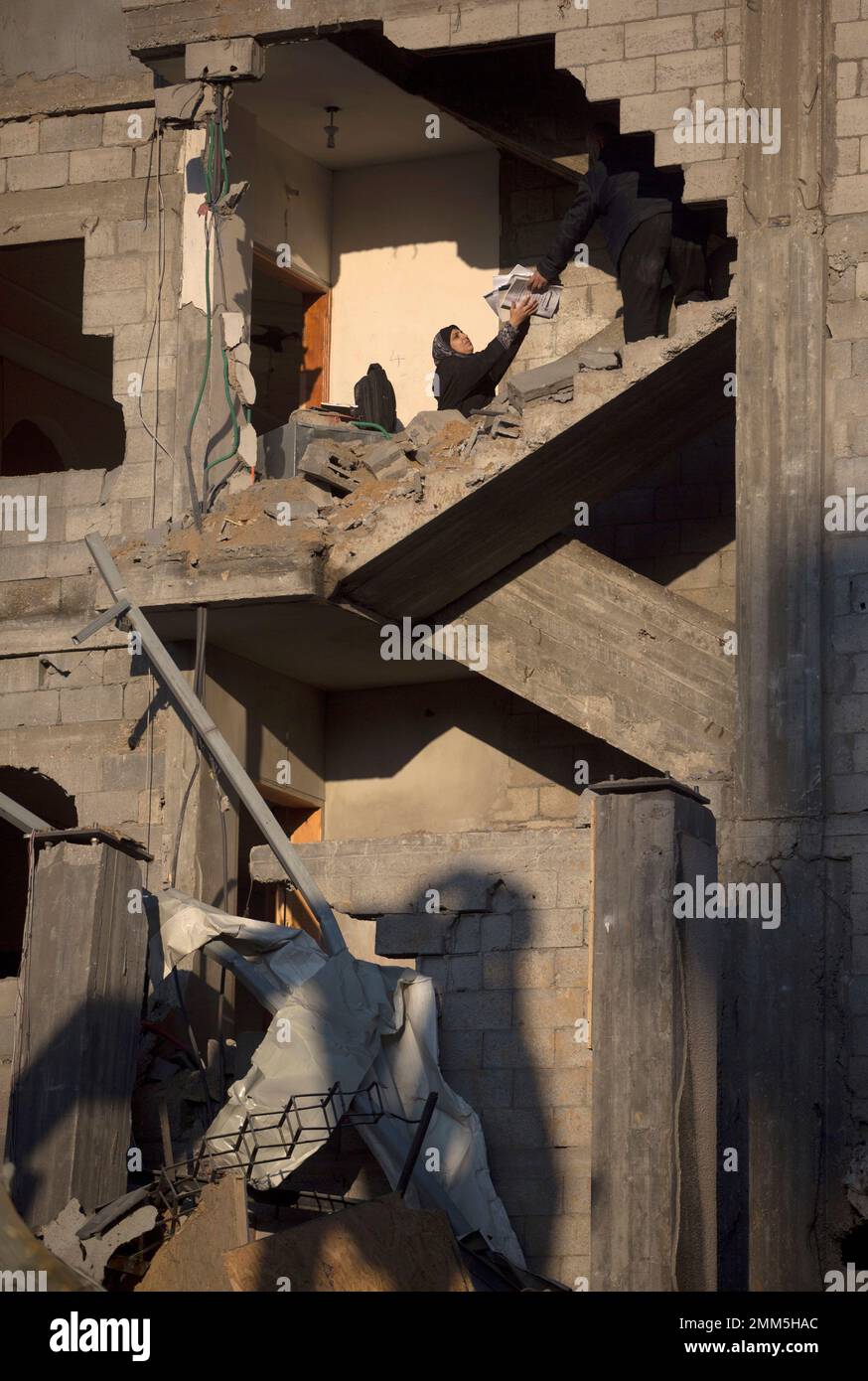 Palestinians check the damage of their home after Israeli airstrikes on ...