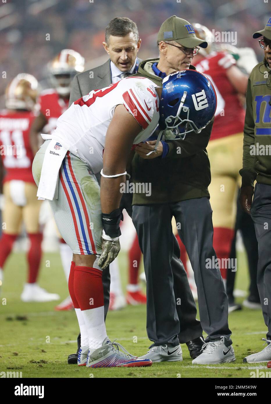New York Giants middle linebacker B.J. Goodson is tended to by trainers ...