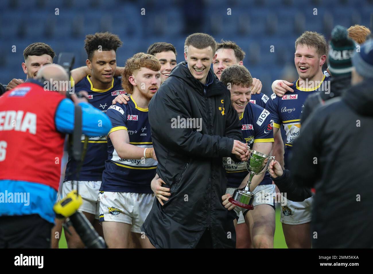 Ash Handley #5 of Leeds Rhinos lifts the trophy and celebrates the win ...
