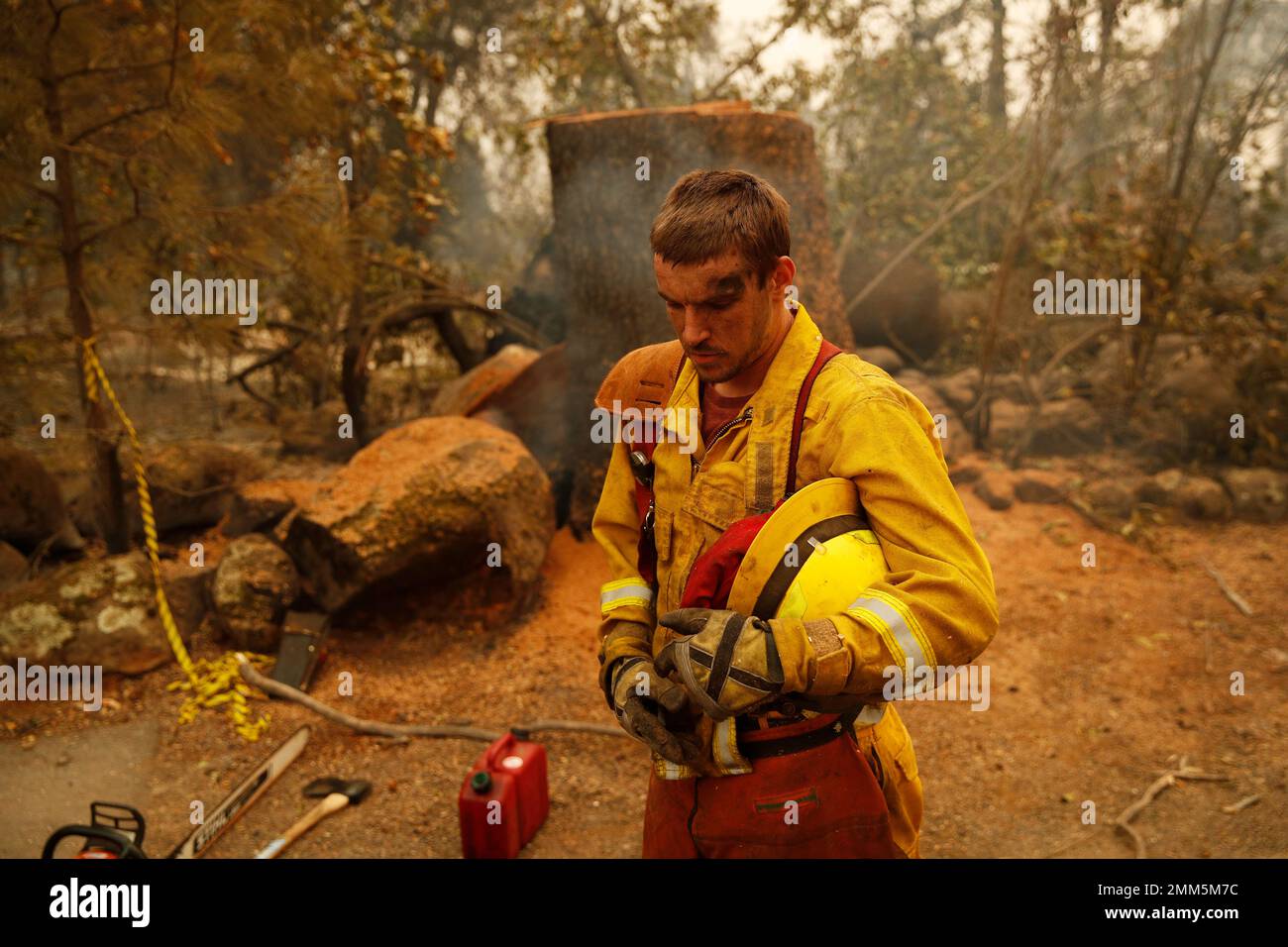 Shawn Slack rests after felling trees burned in the Camp Fire, Monday ...