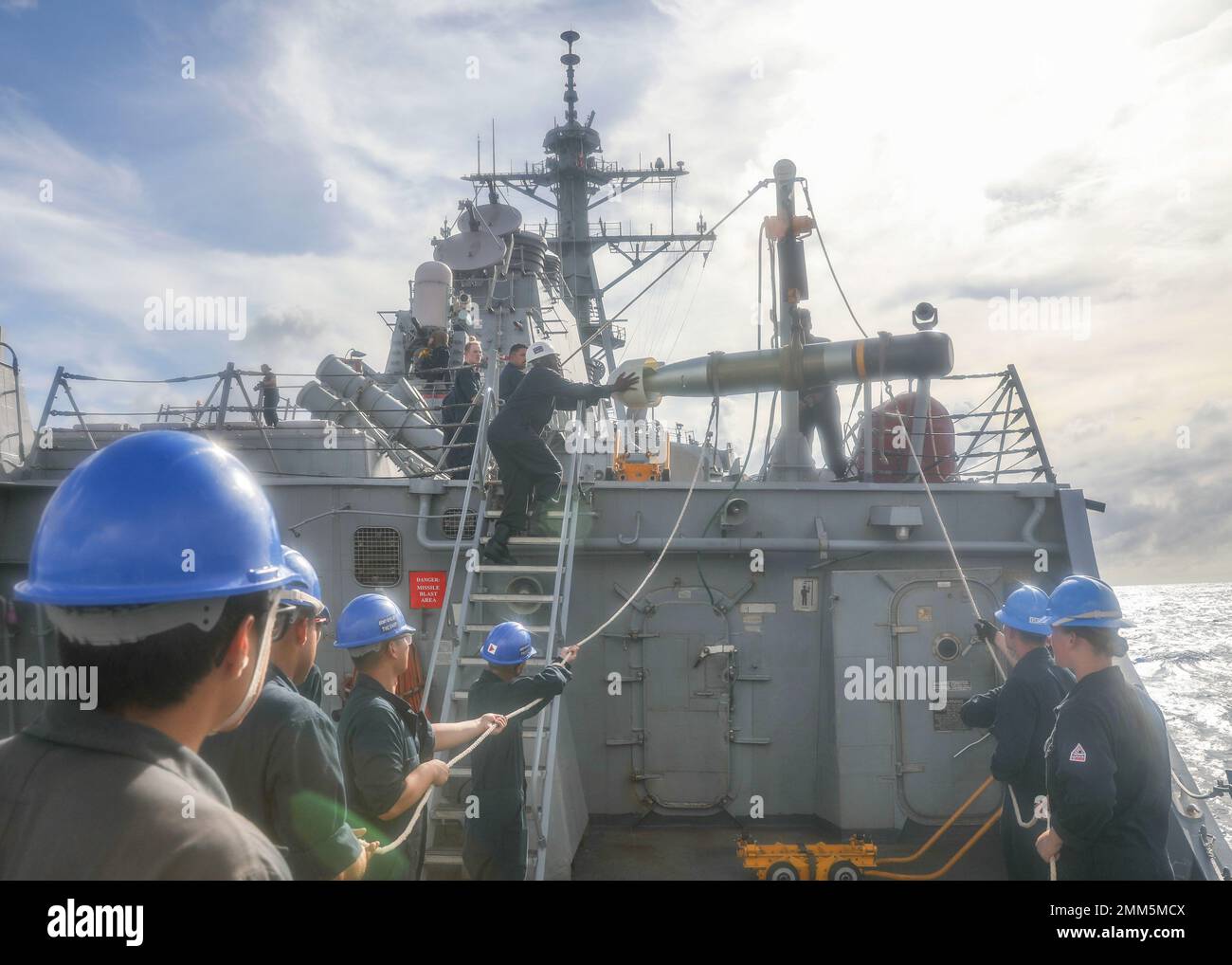 PHILIPPINE SEA (Sep. 14, 2022) Sailors hoist a torpedo onto the aft ...