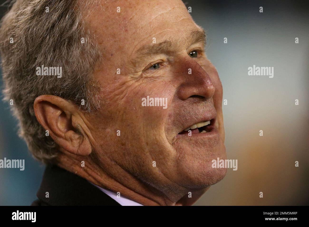President George W. Bush stands on the sidelines before an NFL game ...