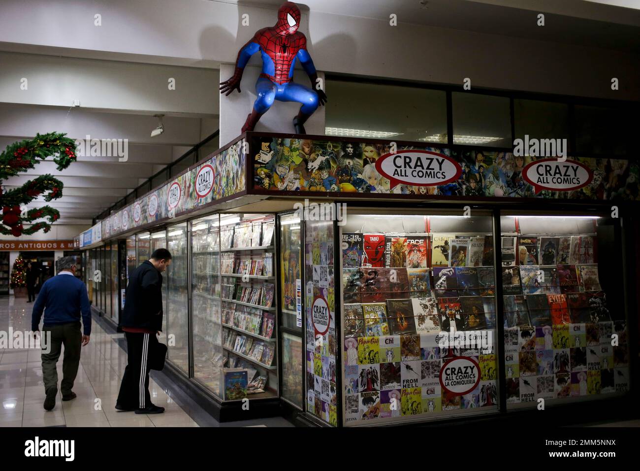 A Spiderman sculpture stands over the display window of a comic store ...