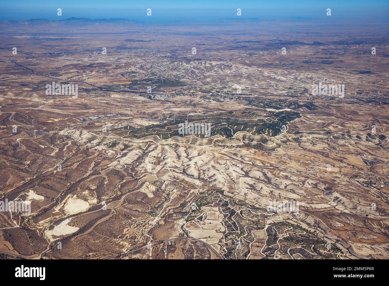 Aerial view from plane window with Moglia Wind Farm in Cyprus island ...