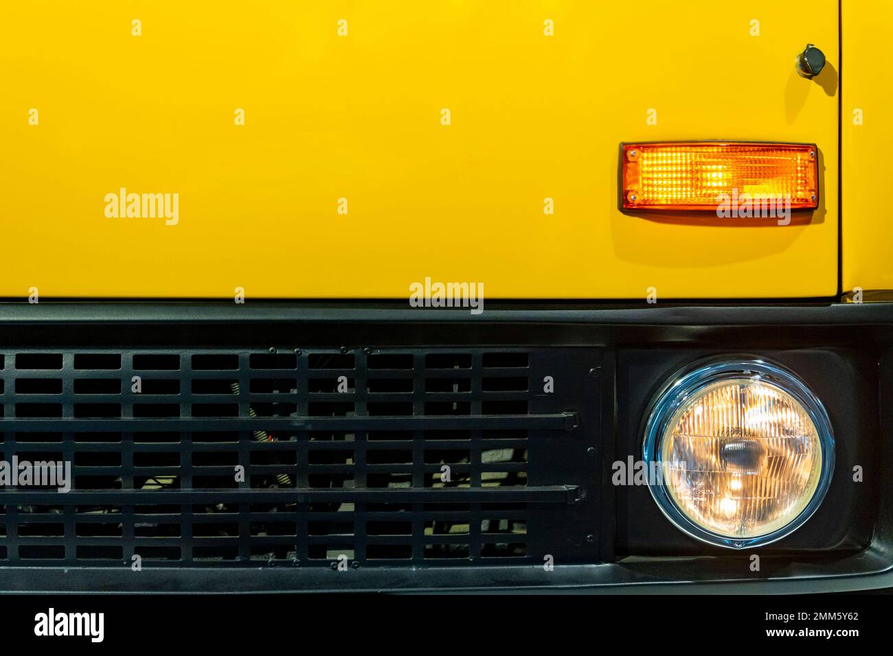 Yellow bus front and front lights Stock Photo - Alamy