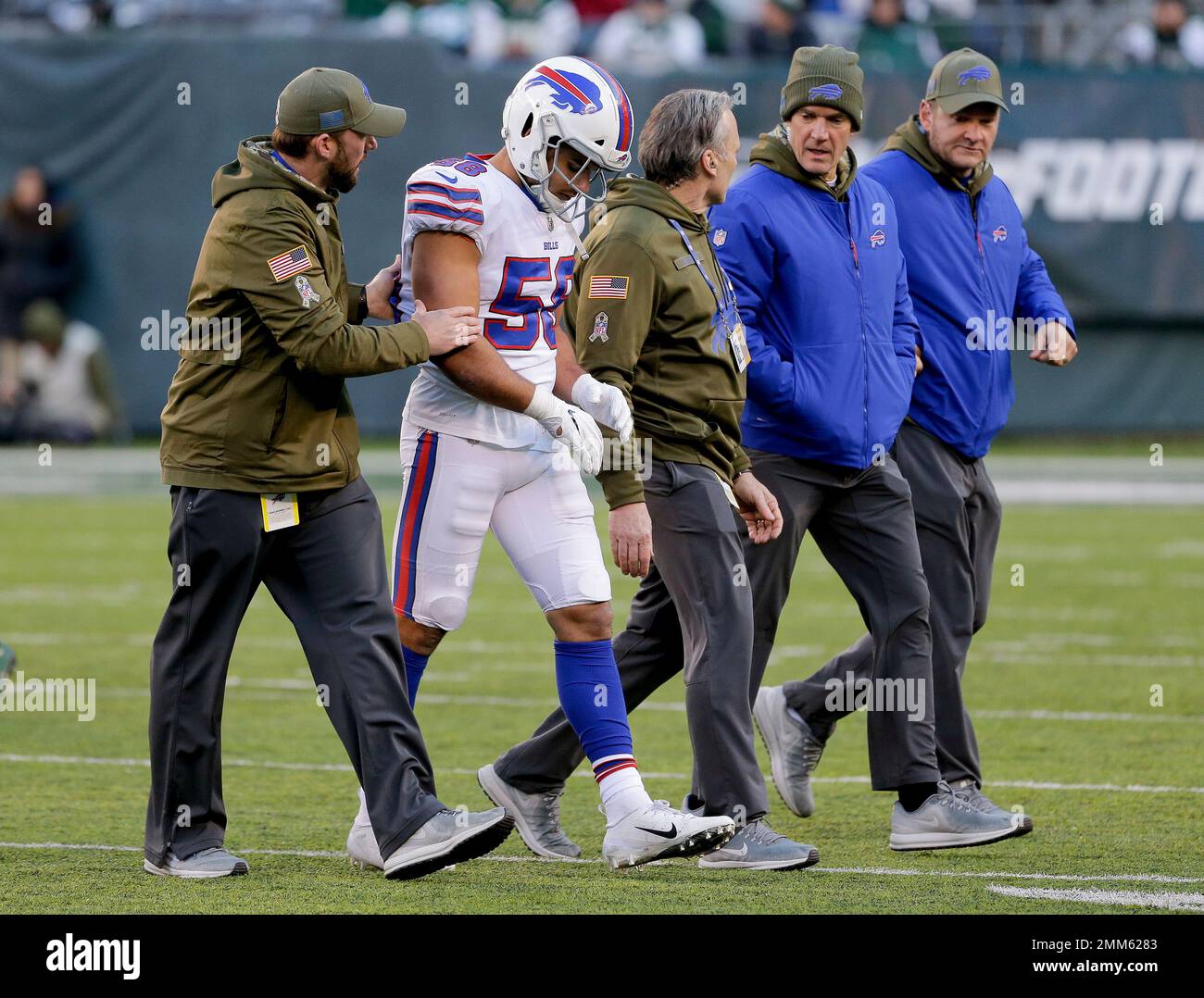 Buffalo Bills defensive end Jerry Hughes (55) is helped off the field ...