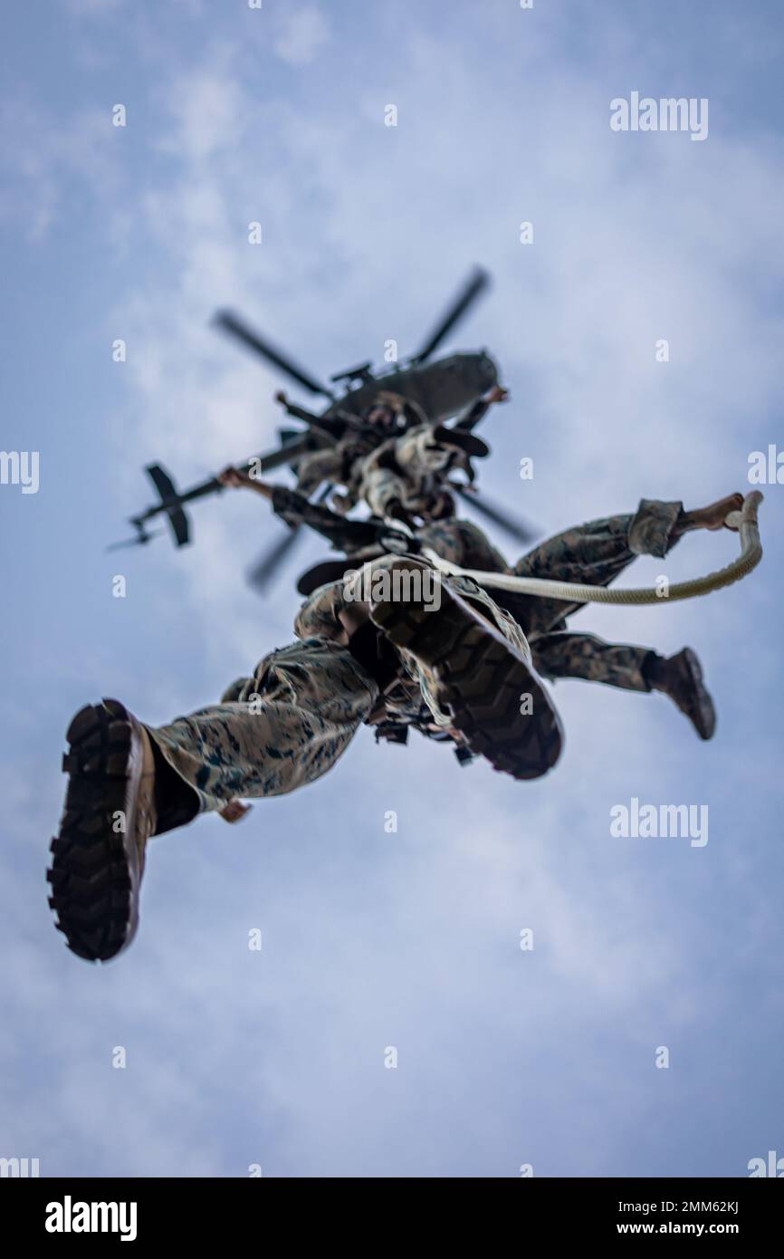 U.S. Marines with III Marine Expeditionary Force (MEF) tack to a UH-1Y ...