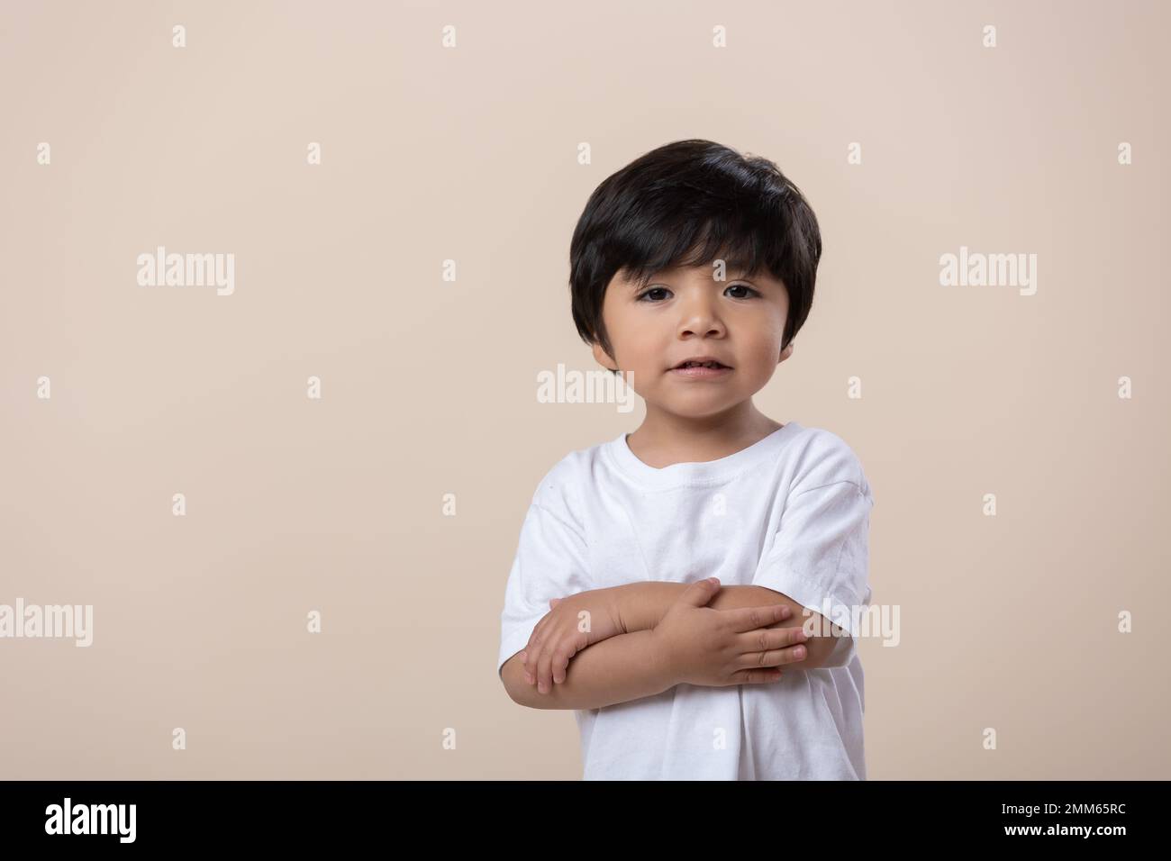 Mexican little boy arms crossed isolated Stock Photo - Alamy