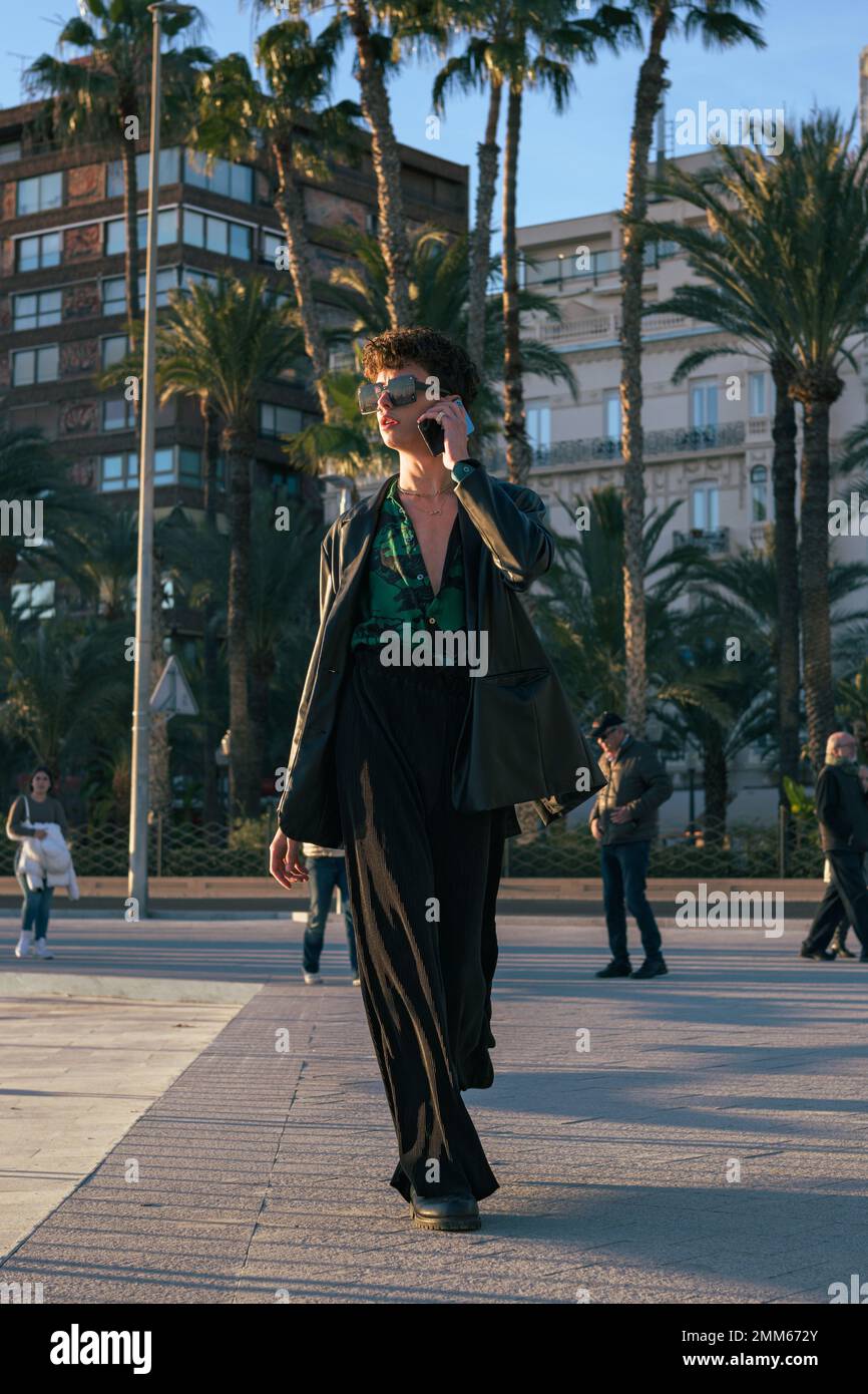 Stylish alternative man with sunglasses talks through his phone Stock ...