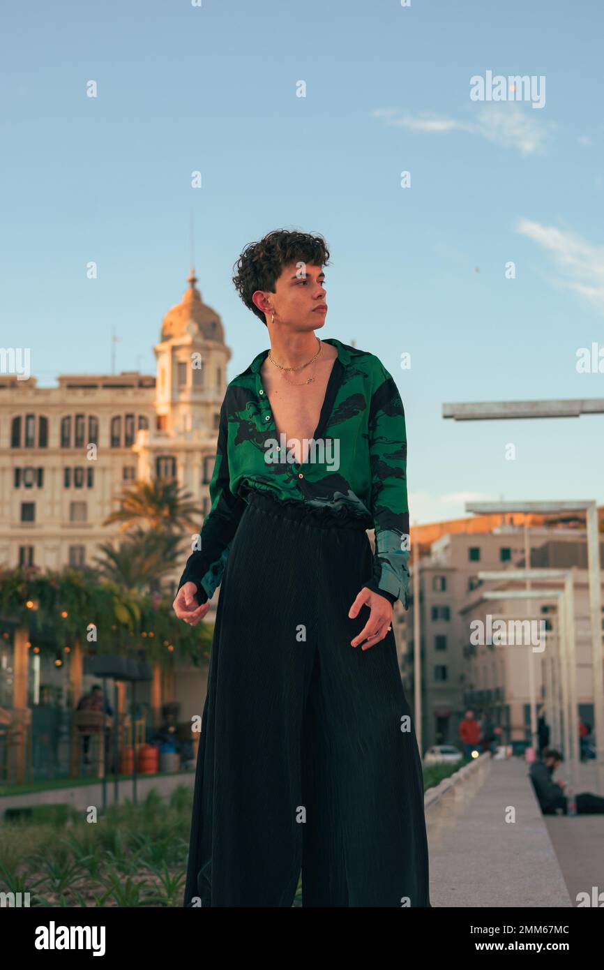 Stylish alternative gay youth man poses in a city at sunset Stock Photo ...