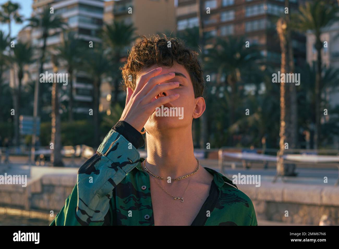 Stylish alternative young man put his hand on the face Stock Photo - Alamy