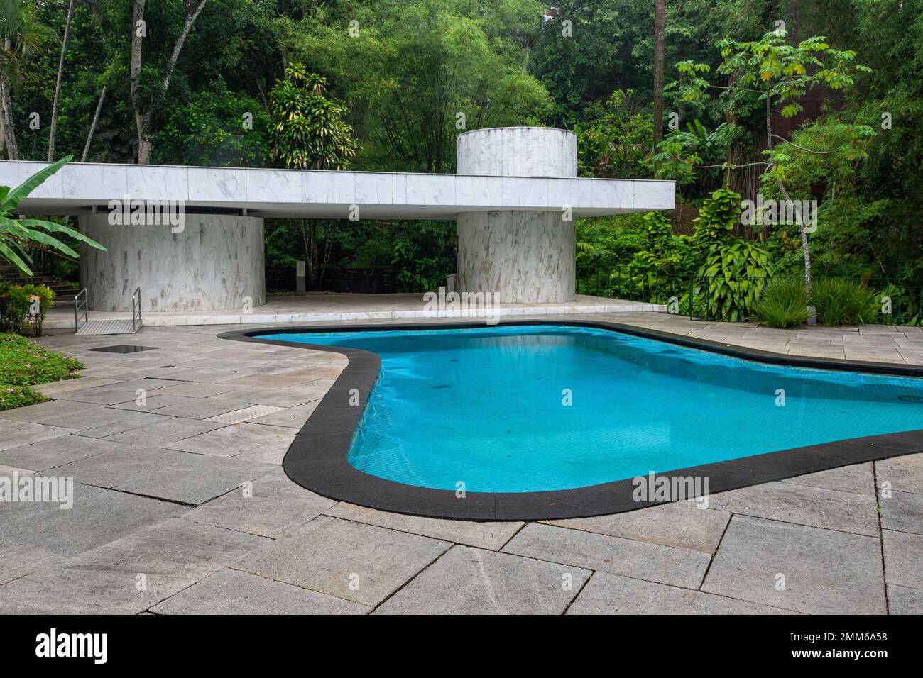 View to beautiful modern house and swimming pool on green rainforest ...
