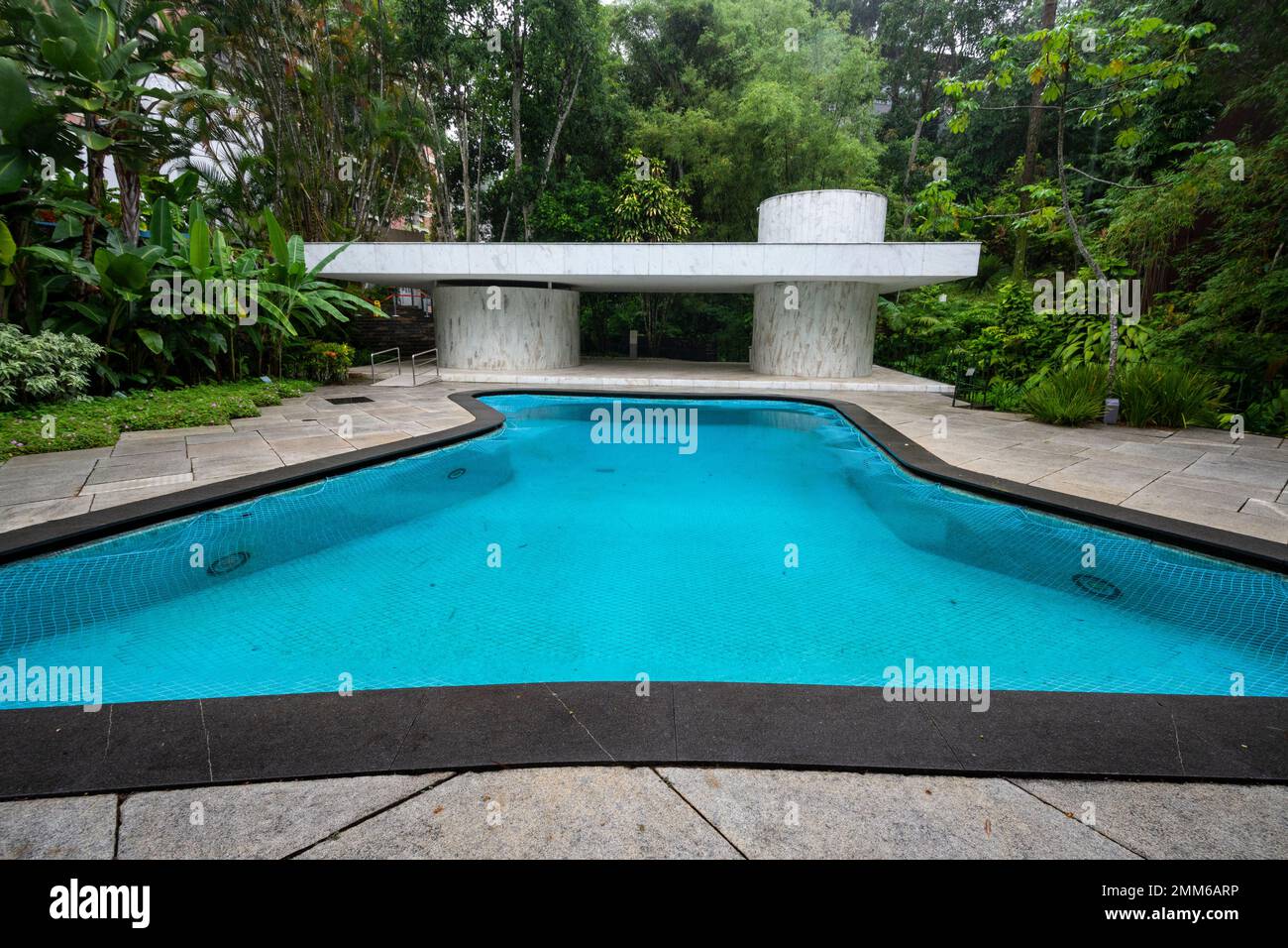 View to beautiful modern house and swimming pool on green rainforest ...