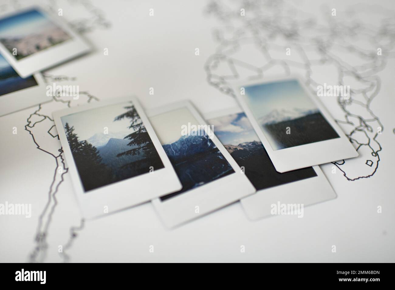 Polaroid Photos Layout of Mountains on Travel World Map Stock Photo - Alamy
