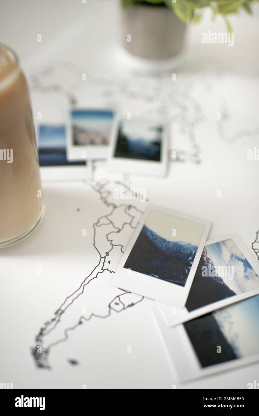 Polaroid Photos on Travel World Map with Iced Coffee and Plant Stock ...