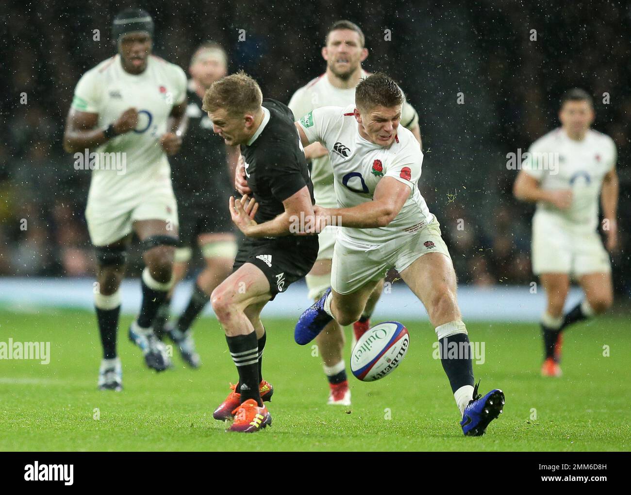 England's Owen Farrell, right, tackles New Zealand's Damian McKenzie ...