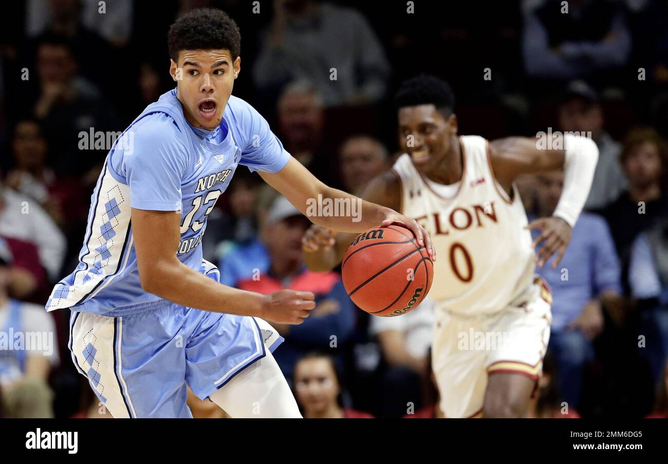 North Carolina's Cameron Johnson (13) dribbles while Elon's Kris Wooten ...
