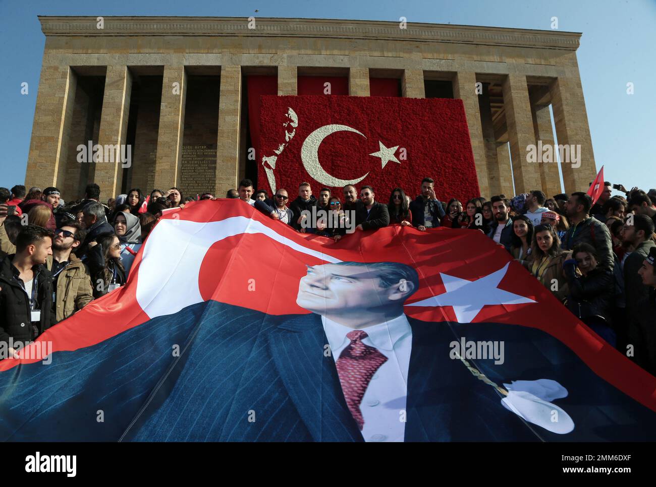 People hold a huge flag at the mausoleum of the nation's founding father Mustafa Kemal Ataturk ...