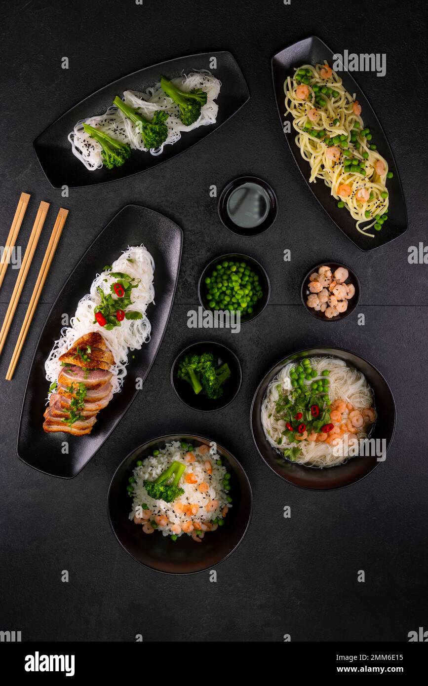 Various dishes of Asian cuisine with different types noodles and rice ...