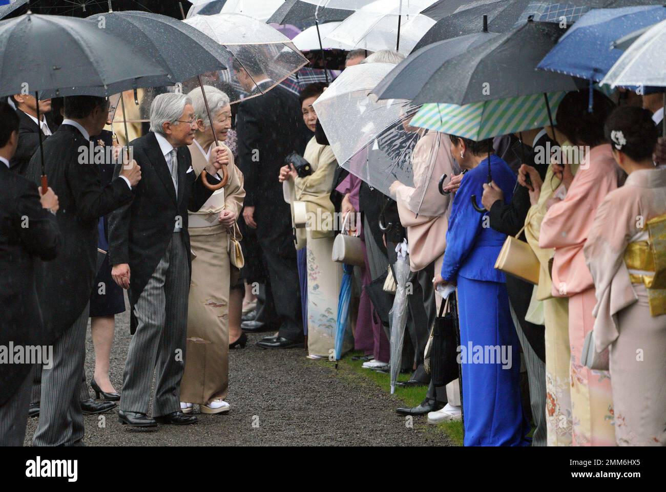 Japan's Emperor Akihito, left, and Empress Michiko, right, greet the ...