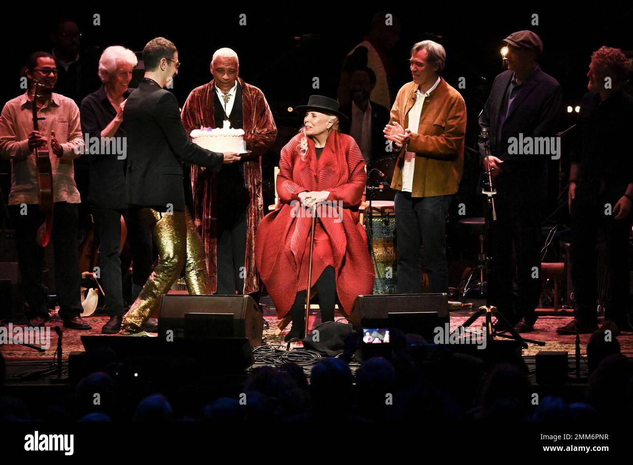 Joni Mitchell is presented with a birthday cake on stage at JONI 75: A ...